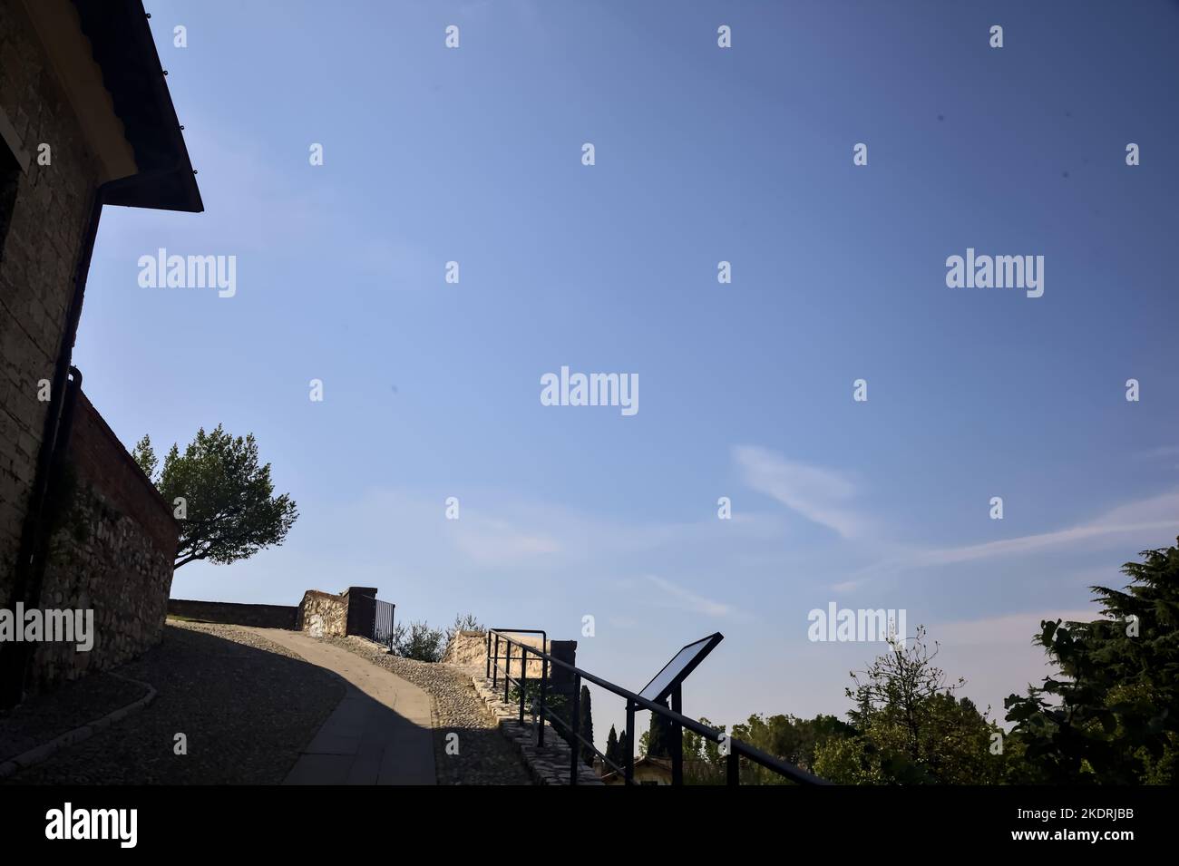 Uphill paved path of a castle with the sky as background Stock Photo ...