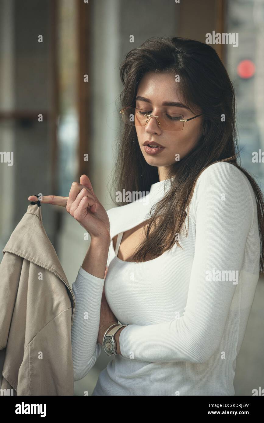 beautiful brunette girl in a sunglasses dressed in white blouse with a ...