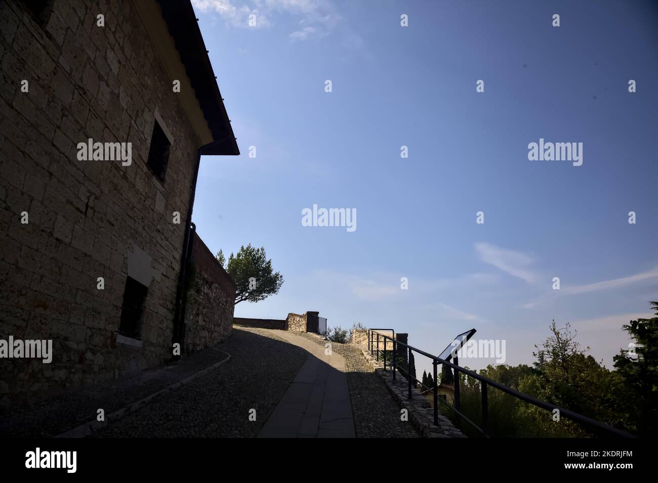 Uphill paved path of a castle with the sky as background Stock Photo ...