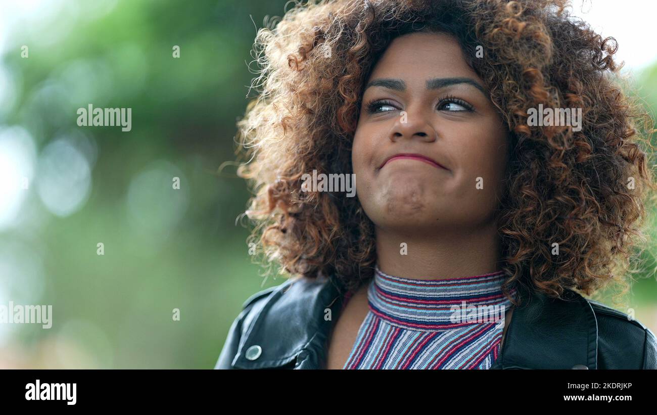 Pensive African descent woman. Contemplative Brazilian girl standing ...