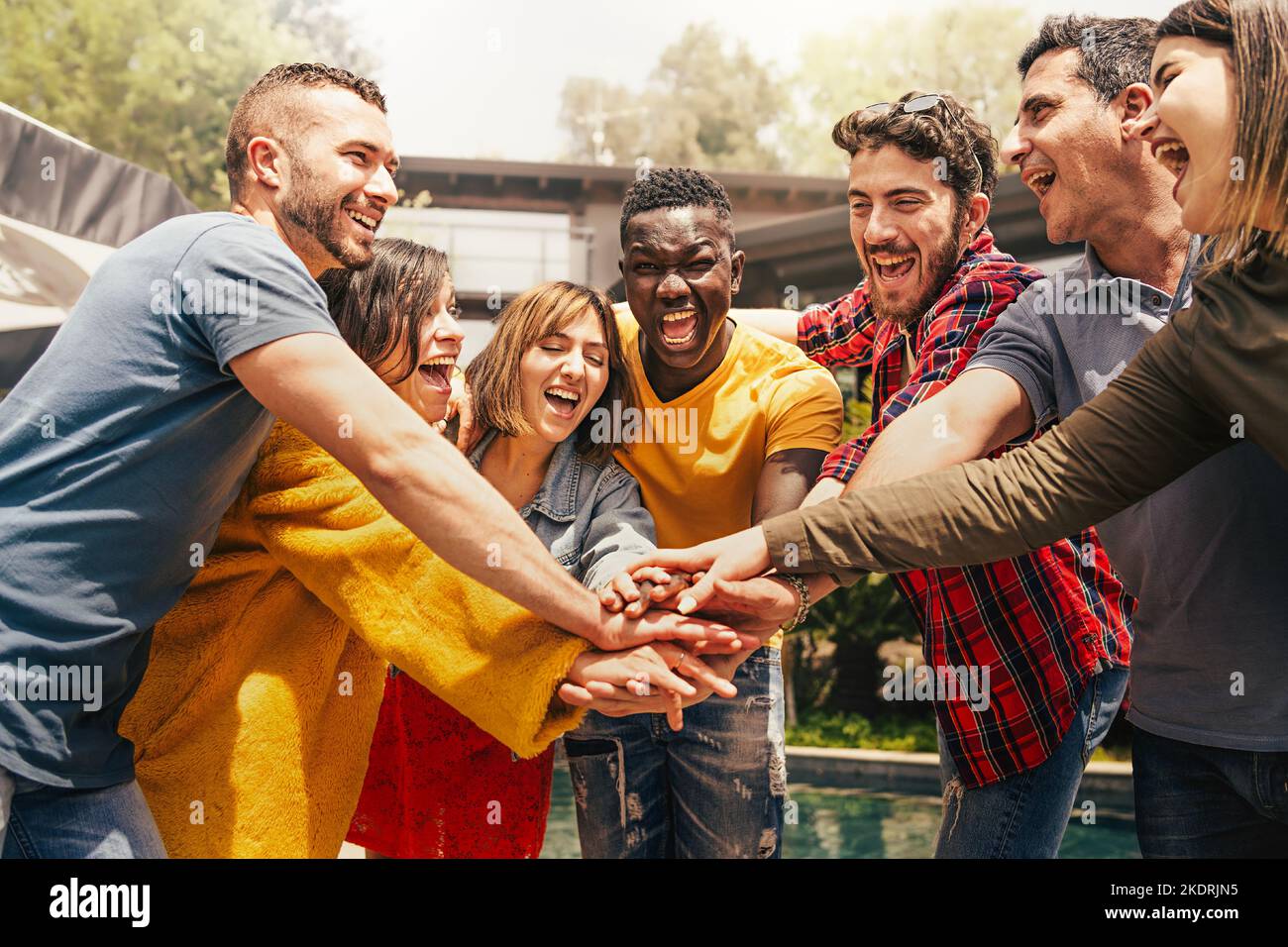 Joyful Multiethnic Teamwork Of Young People Having Fun Joining Hands