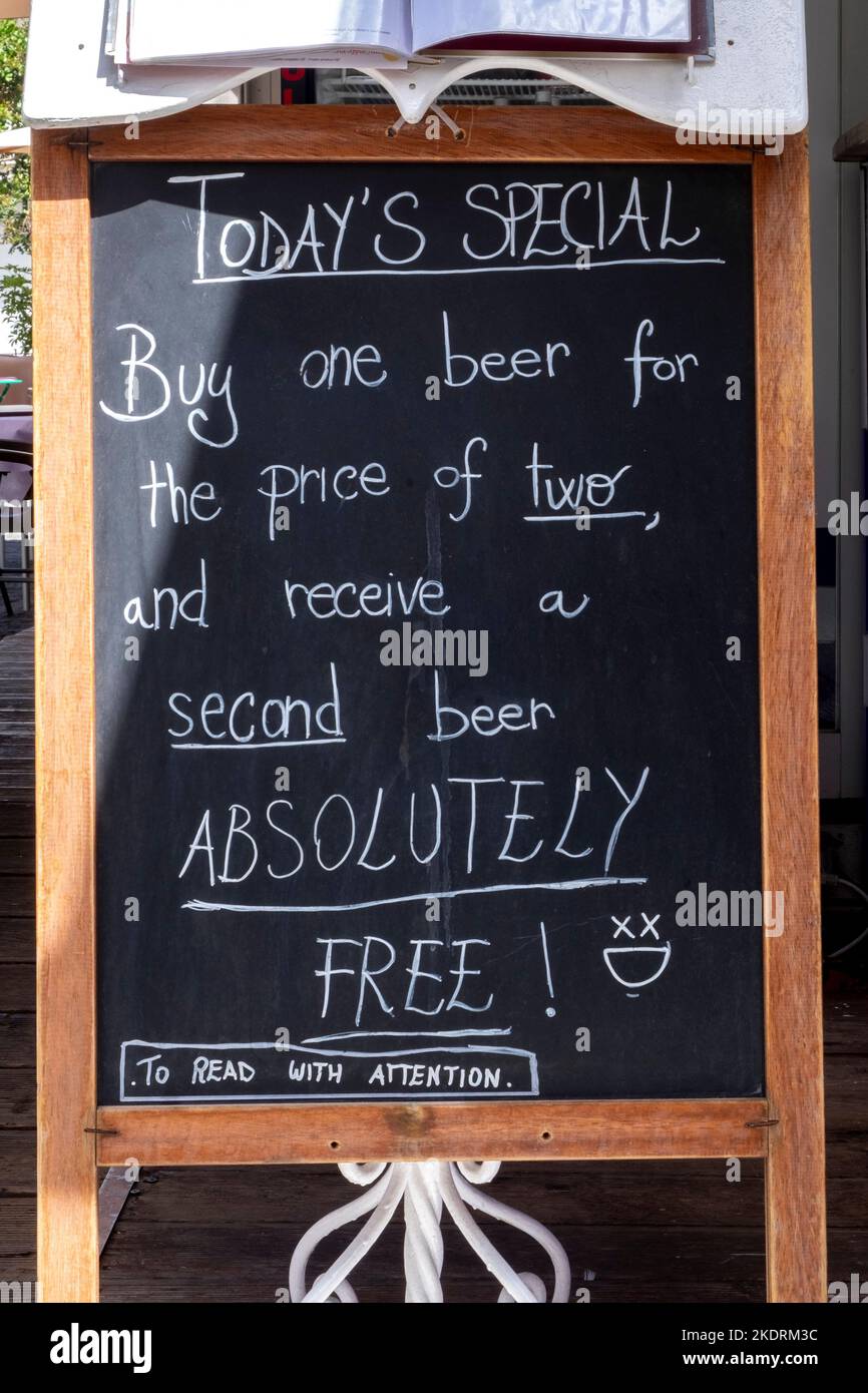 Funny chalkboard advertising a 2 for 1 offer on beer Stock Photo - Alamy