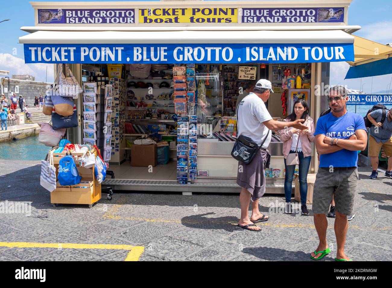 People buying boat tickets at a ticket booth on Capri foir a trip ...