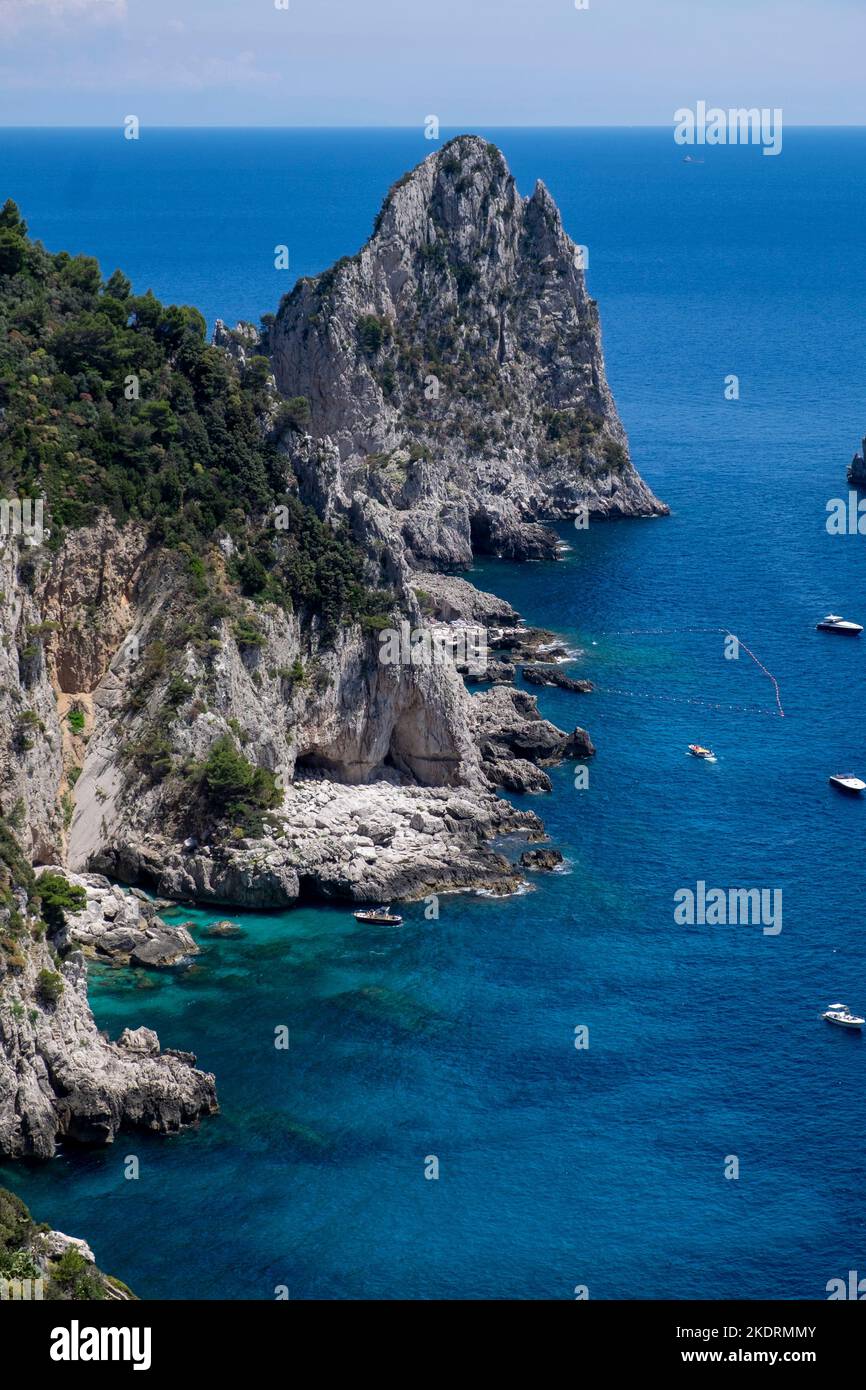 Photograph showing the cliffs on Island of Capri surrounded by crystal ...