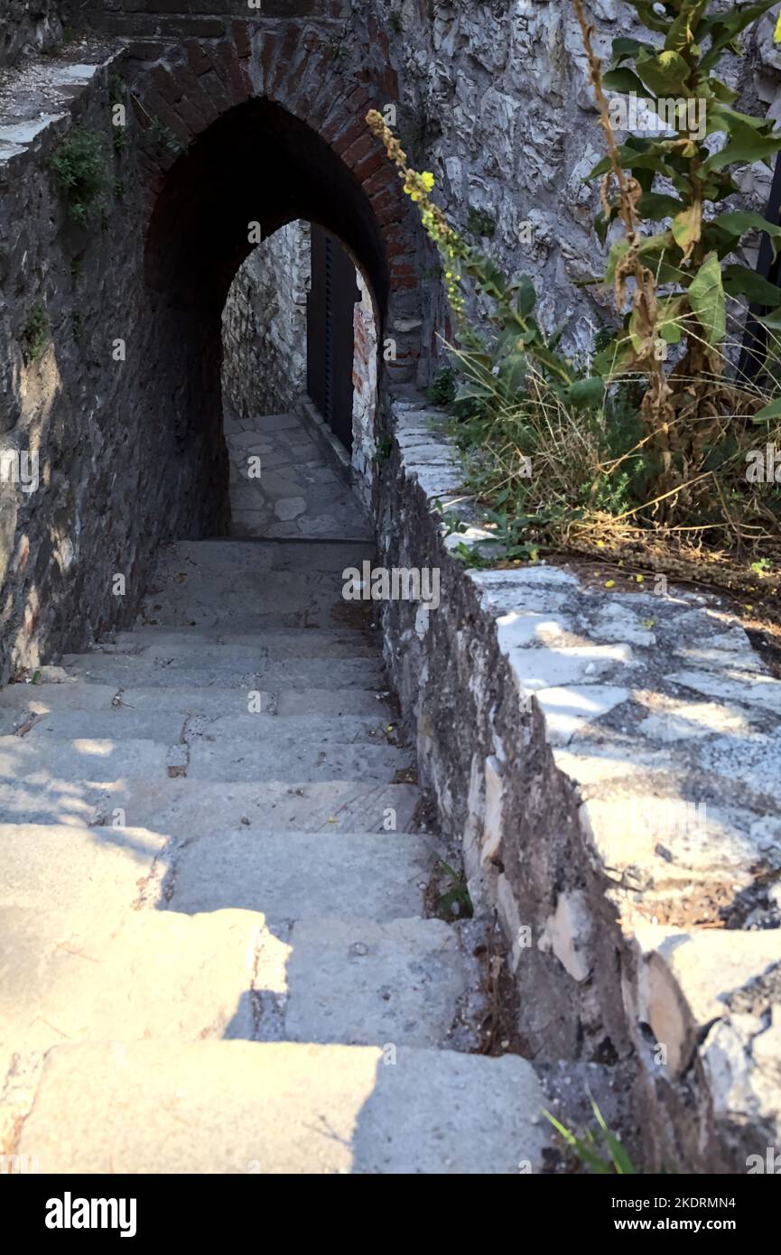 Stone staircase passing under an arch in a castle Stock Photo - Alamy