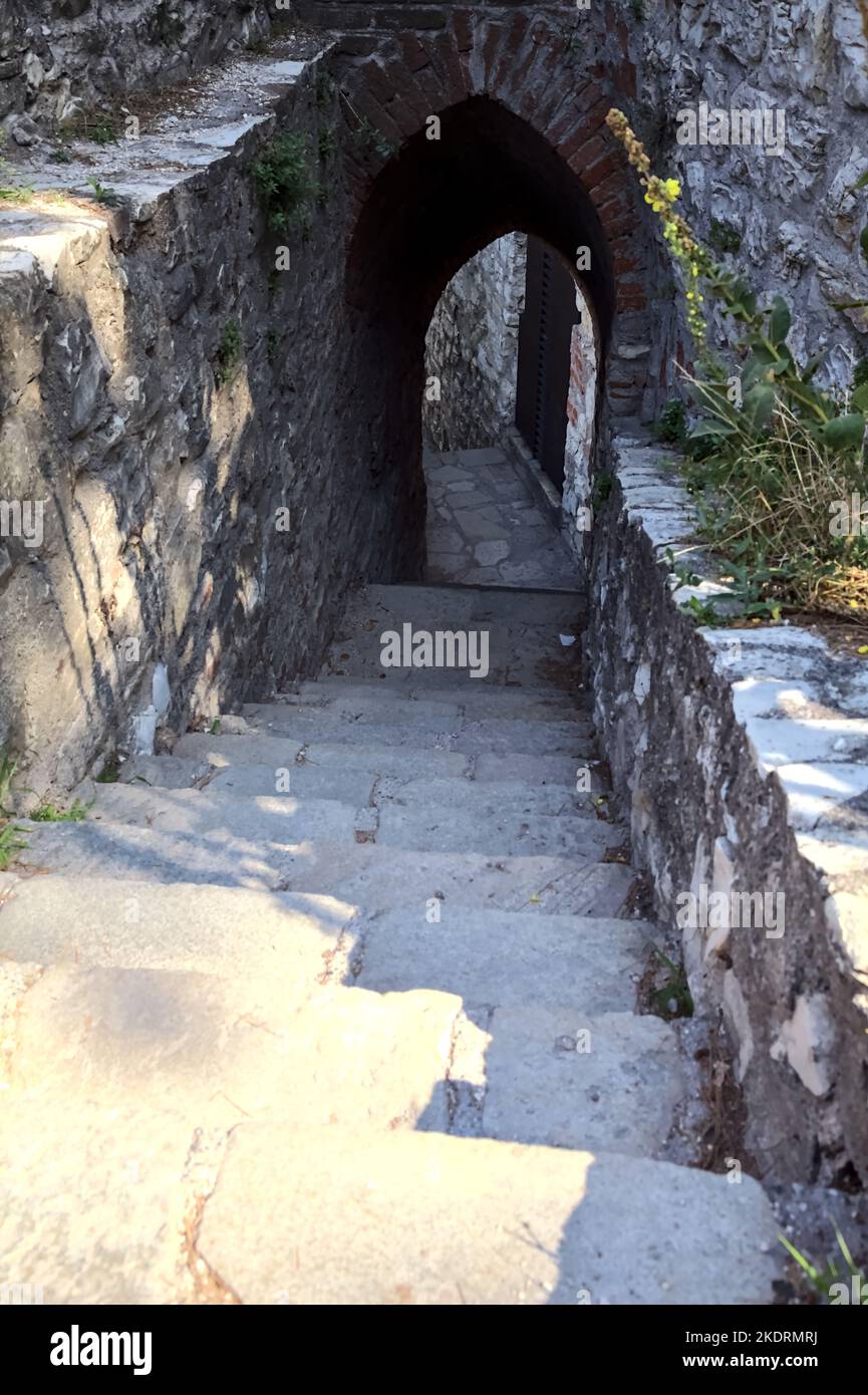 Stone staircase passing under an arch in a castle Stock Photo - Alamy