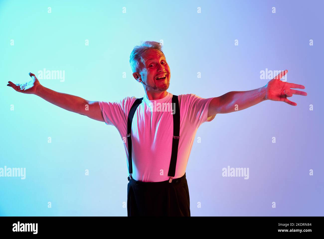 Portrait of mature man in shirt posing isolated over gradient purple ...