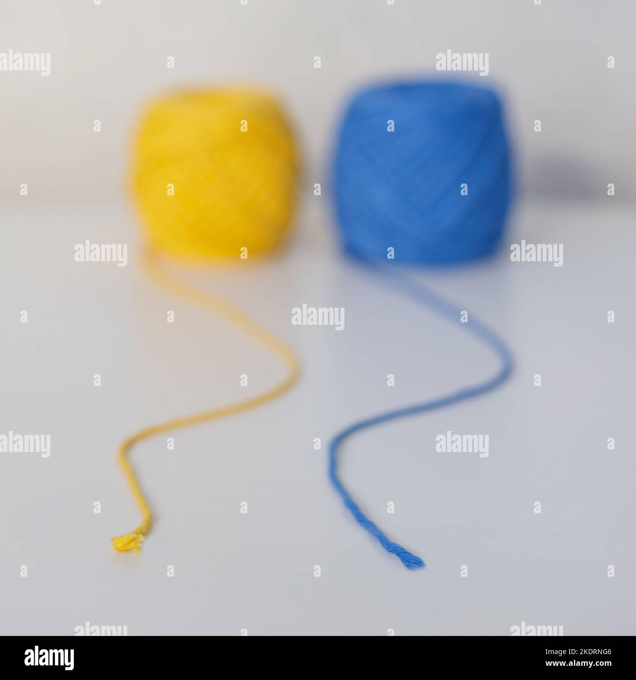 Yellow and blue threads close-up on a background of yellow and blue ...