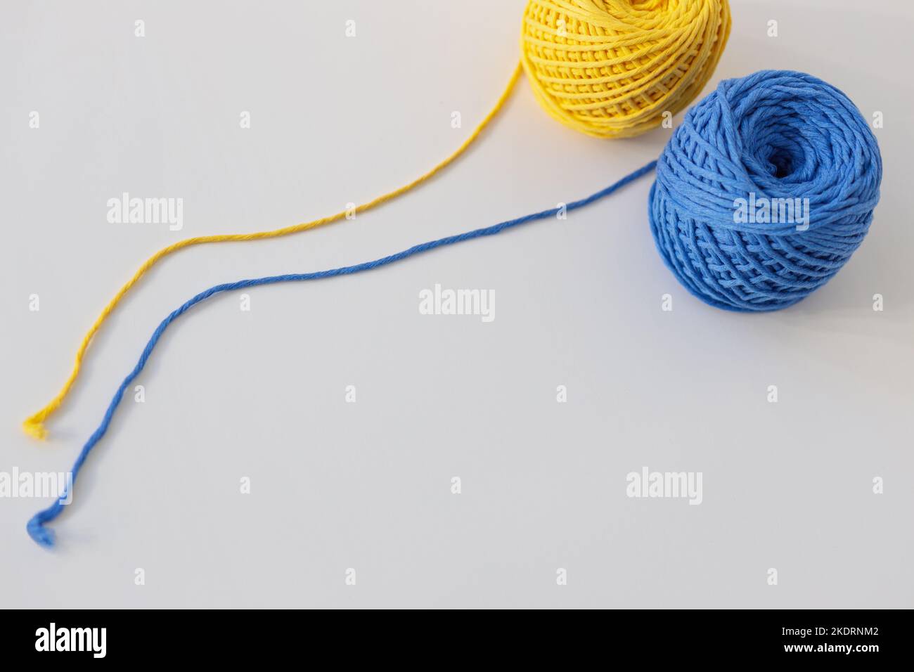 Yellow and blue threads on a gray background with a place for writing Stock Photo - Alamy