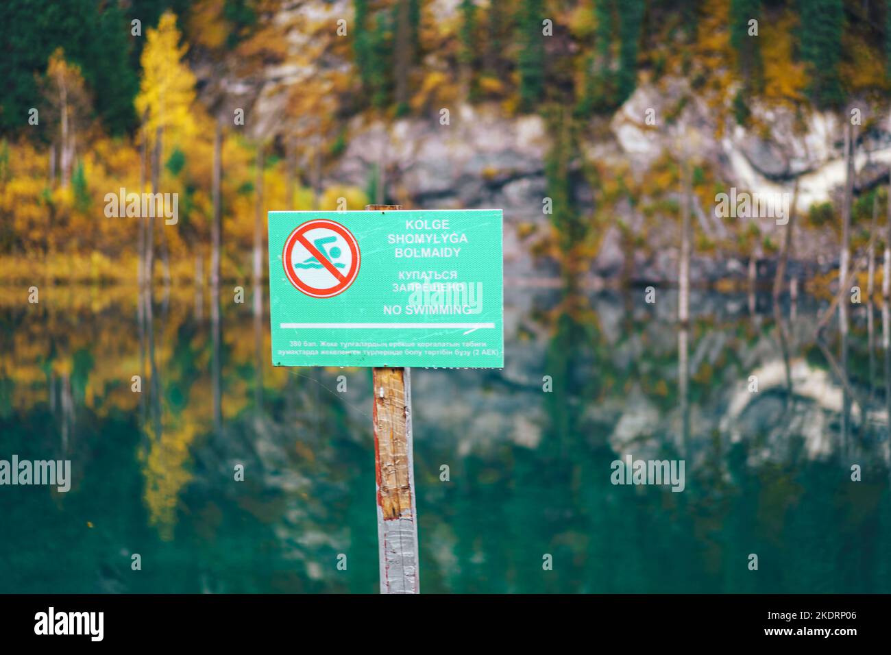 Warning sign about the prohibition of swimming in a mountain lake Stock ...