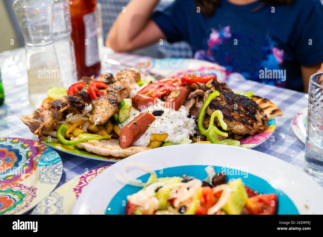 Family eating traditional Greek food in restaurant tavern in Greece ...