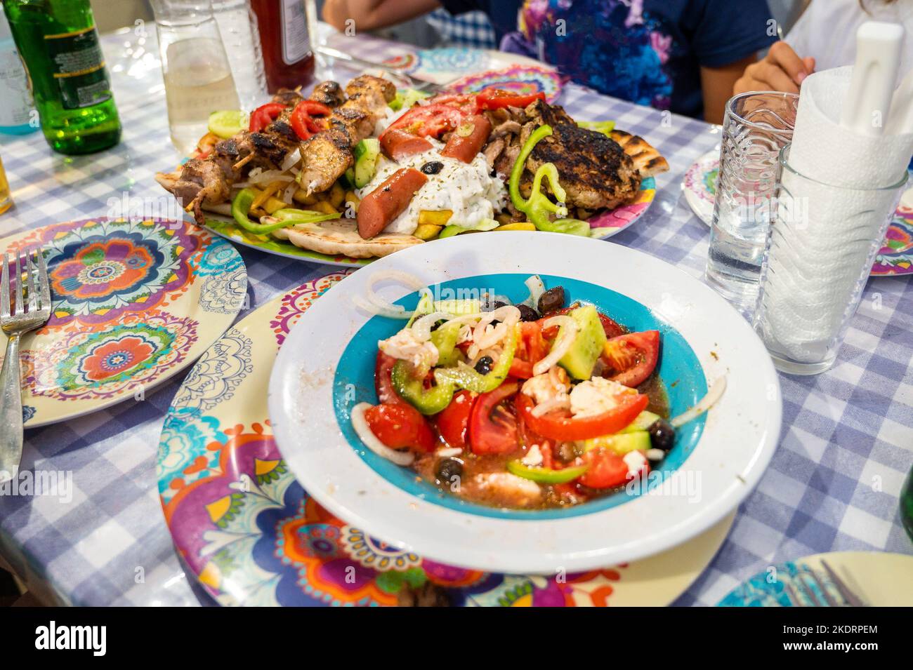 Family eating traditional Greek food in restaurant tavern in Greece ...