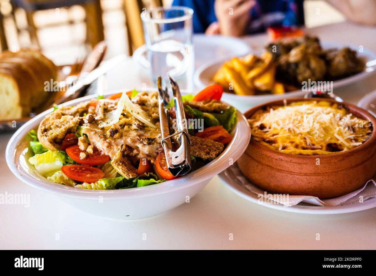 Family eating traditional Greek food in restaurant tavern in Greece ...
