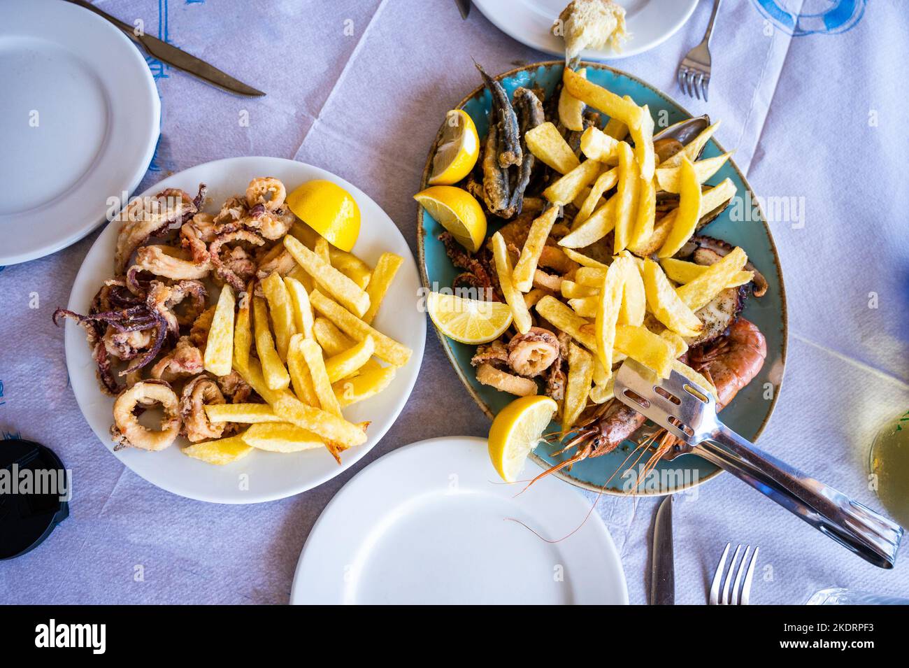 Family eating traditional Greek food in restaurant tavern in Greece ...