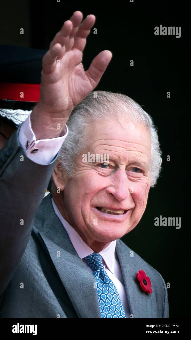 King Charles III waving to members of the public after attending at a ...