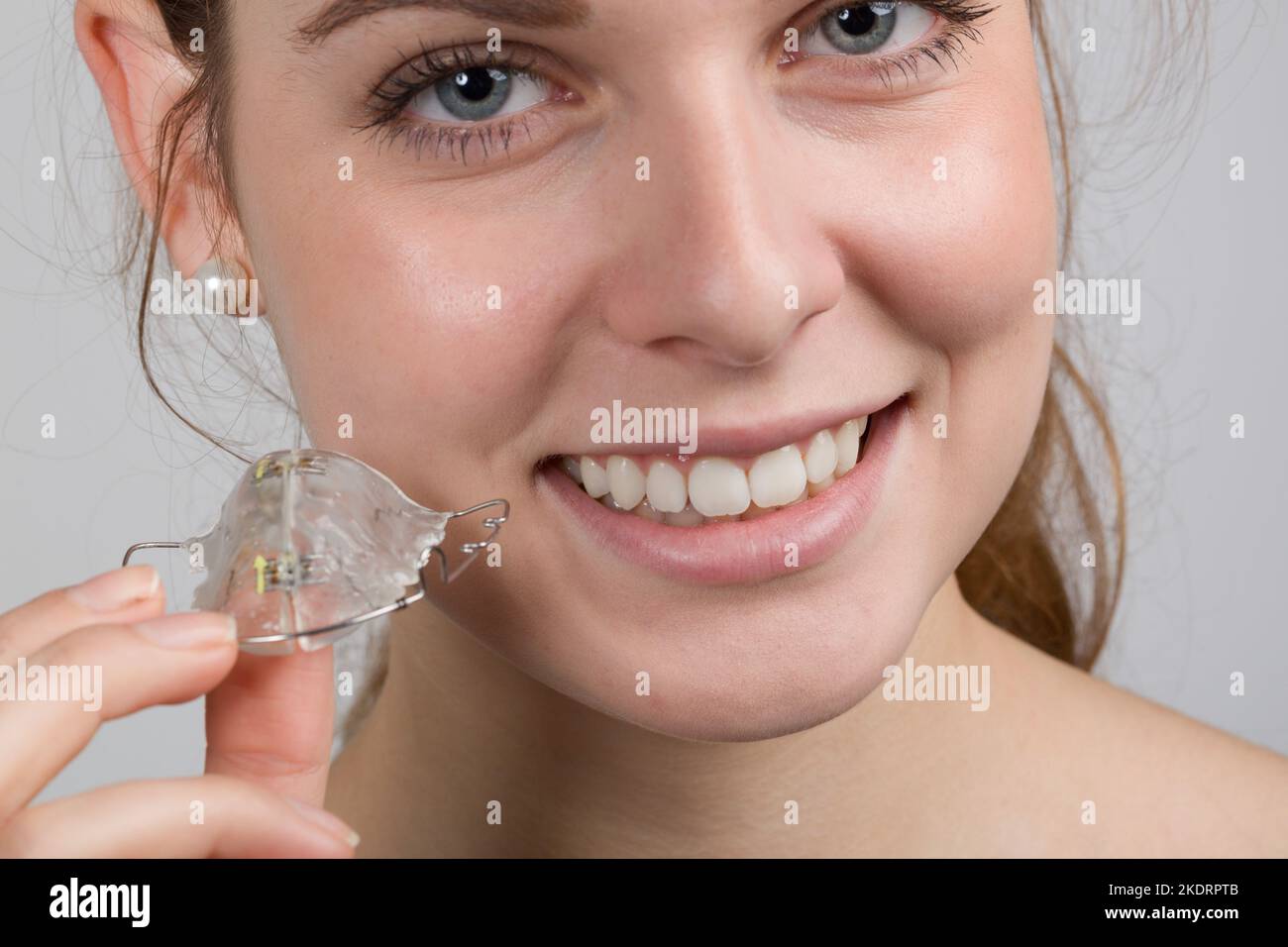 young girl is smiling and shows her removable dental brace Stock Photo ...