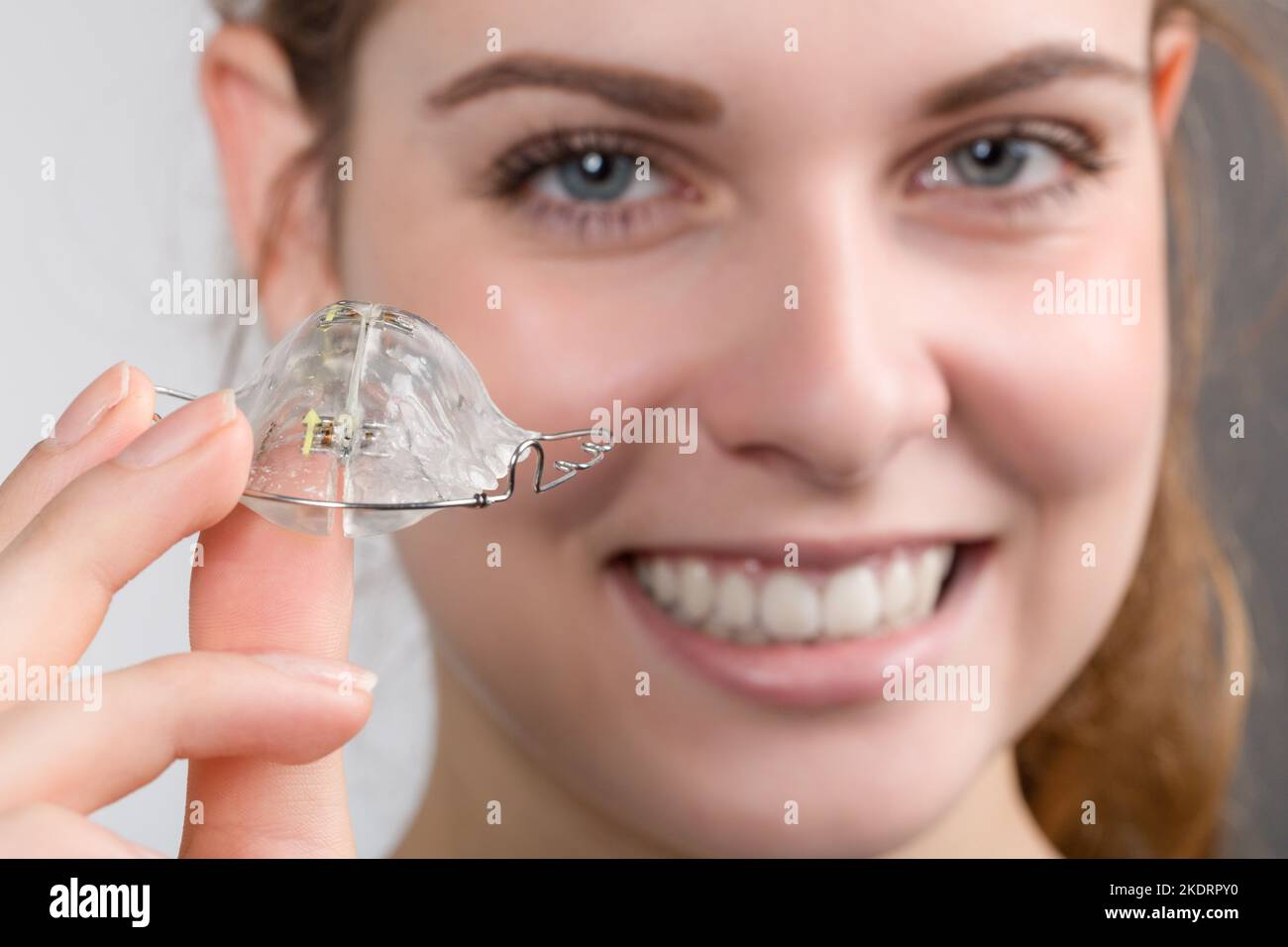 young girl is smiling and shows her removable dental brace Stock Photo ...