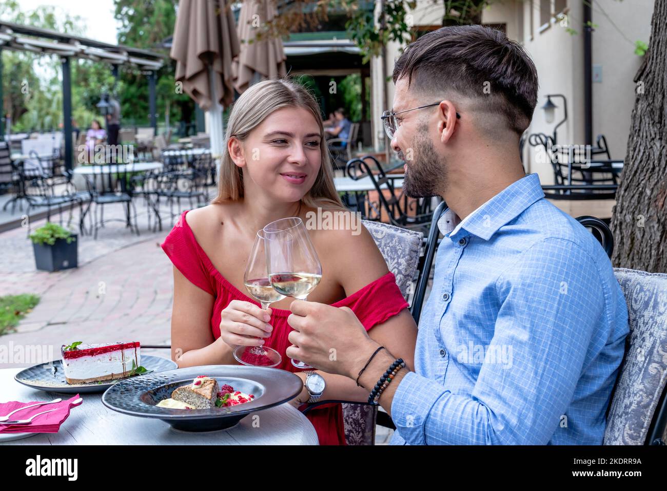 Happy romantic couple laughing and having a good time at dinner or ...