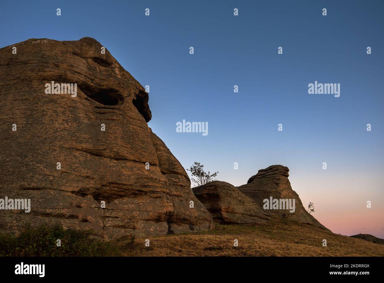 Sacred rocks, mountains in the shape of a head illuminated by the ...