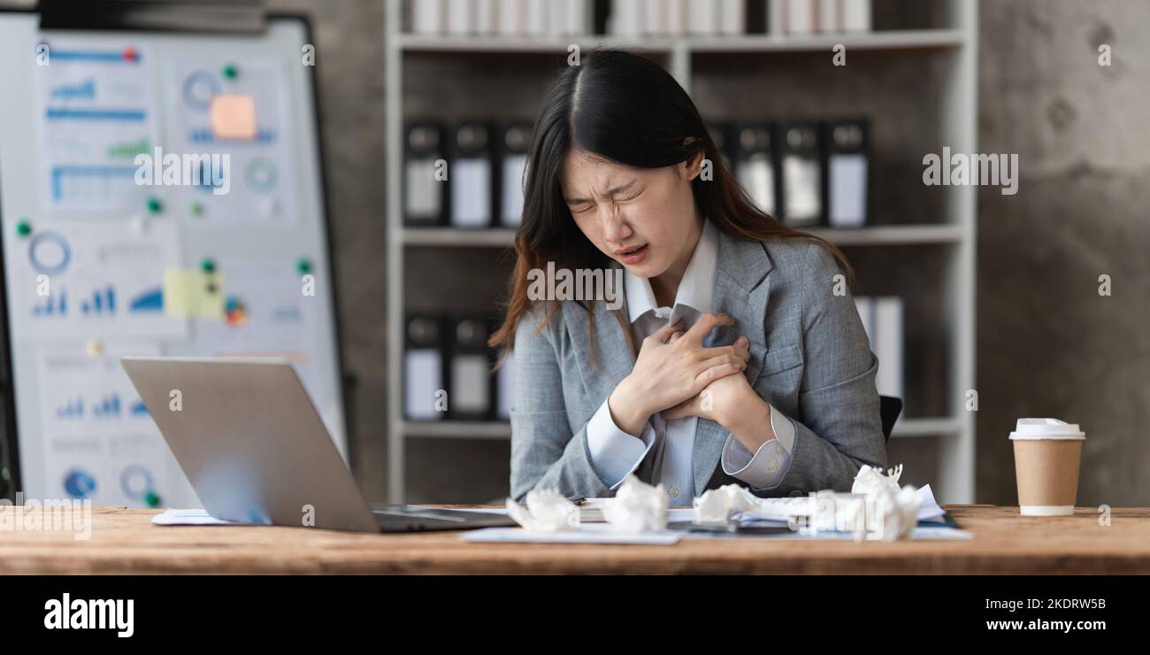 Stressed Asian business woman worry about marketing plan of this years ...
