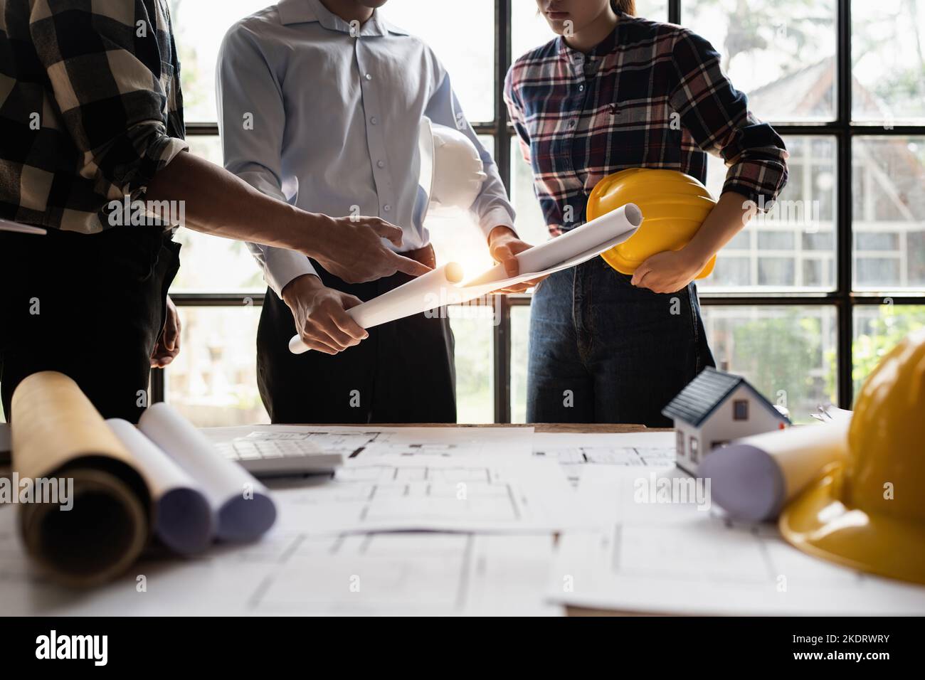 Architect team working with blueprints for architectural plan, engineer ...