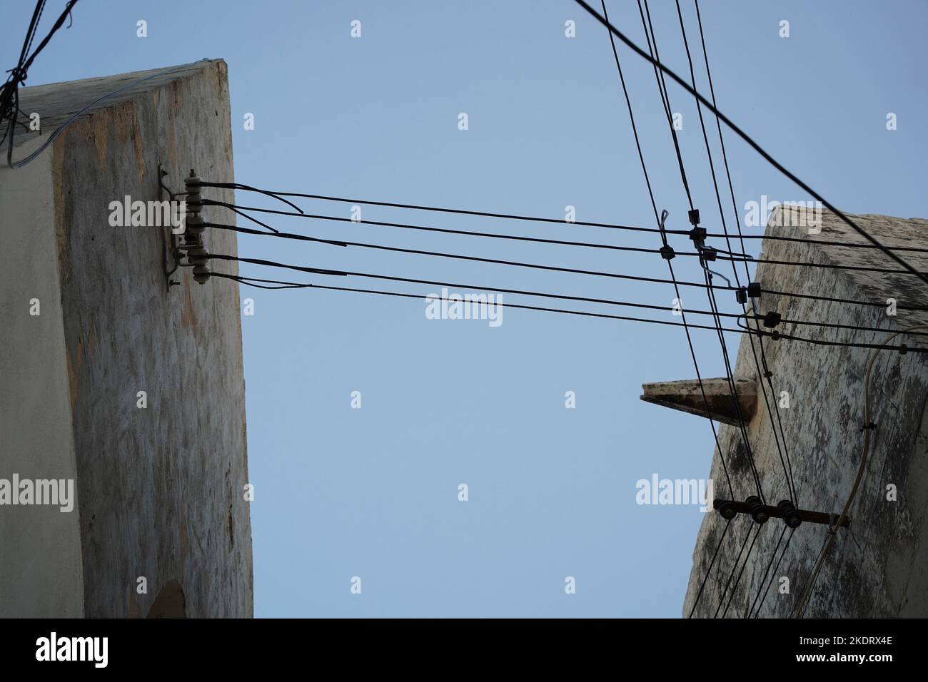 Malta electric wires hanging on building detail Stock Photo - Alamy