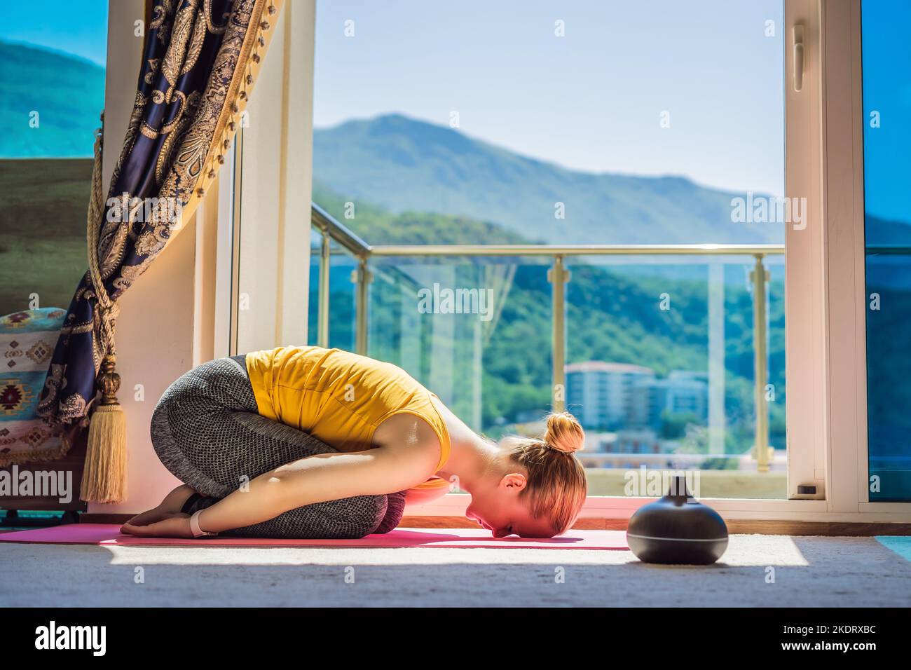 Mindful healthy woman practicing yoga at home. Sitting on the floor ...