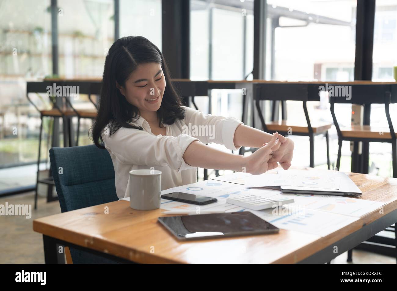 Young Asian Business Accountant woman stretching herself and relax ...