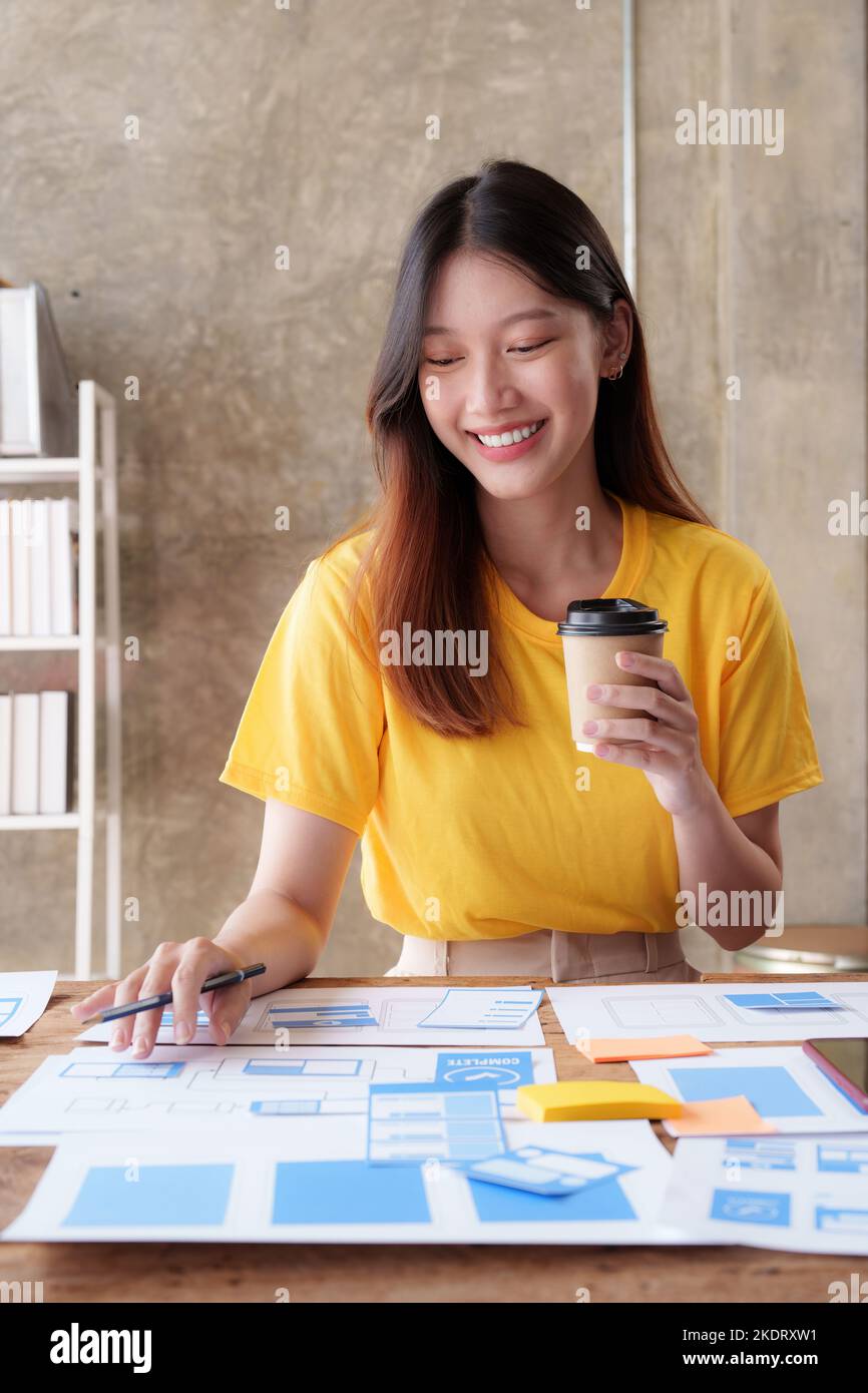 UX Developer and ui designer brainstorming about app interface design at modern office. Creative ...