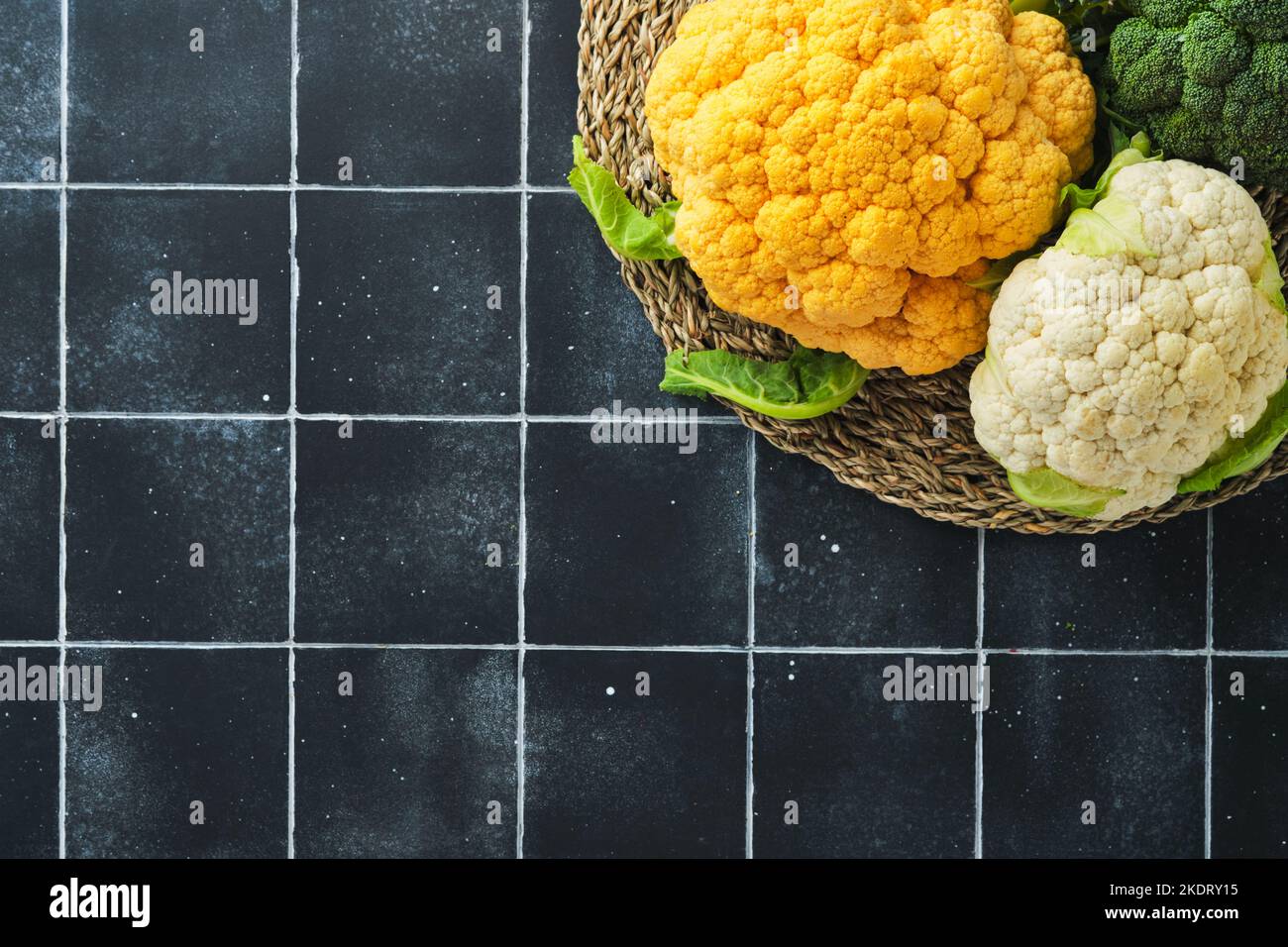 Colorfu cauliflower. Various sort of cauliflower on old stone tiles ...