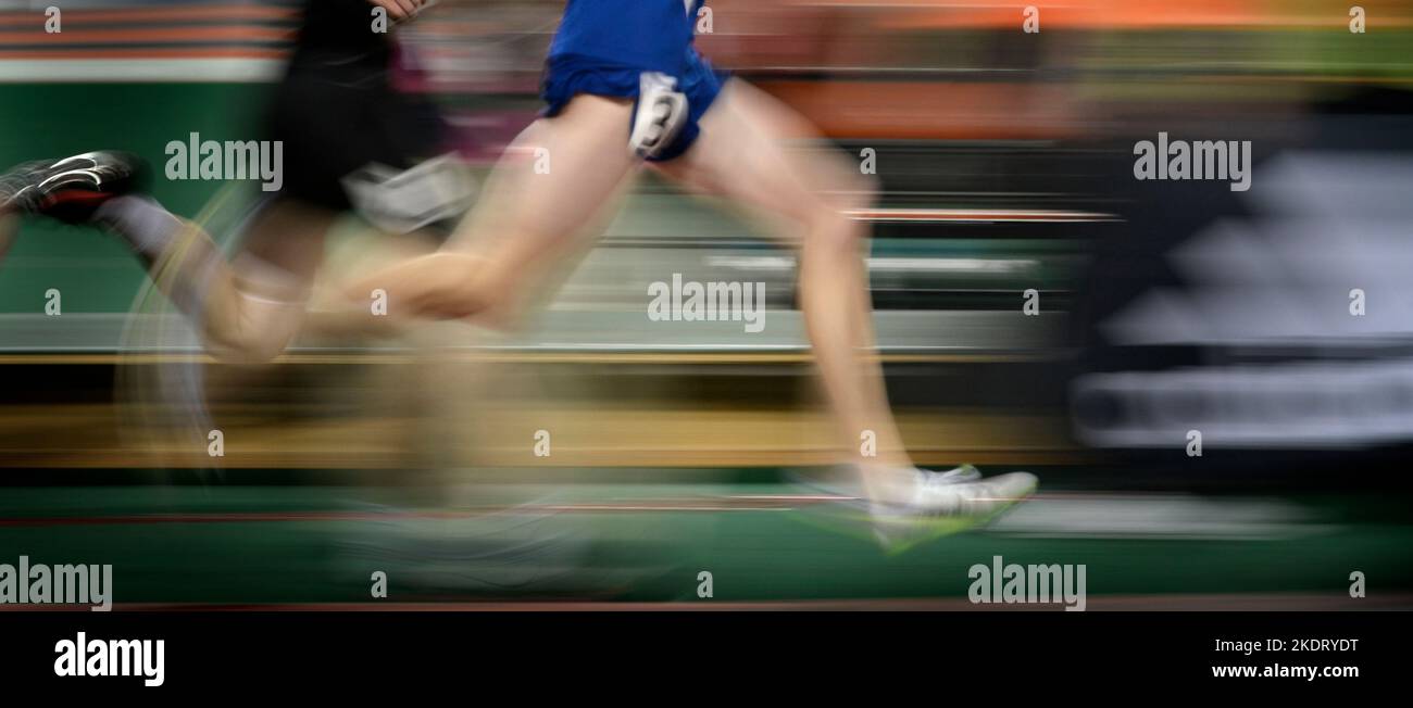 Runner running a race around a track with lines holding baton relay ...