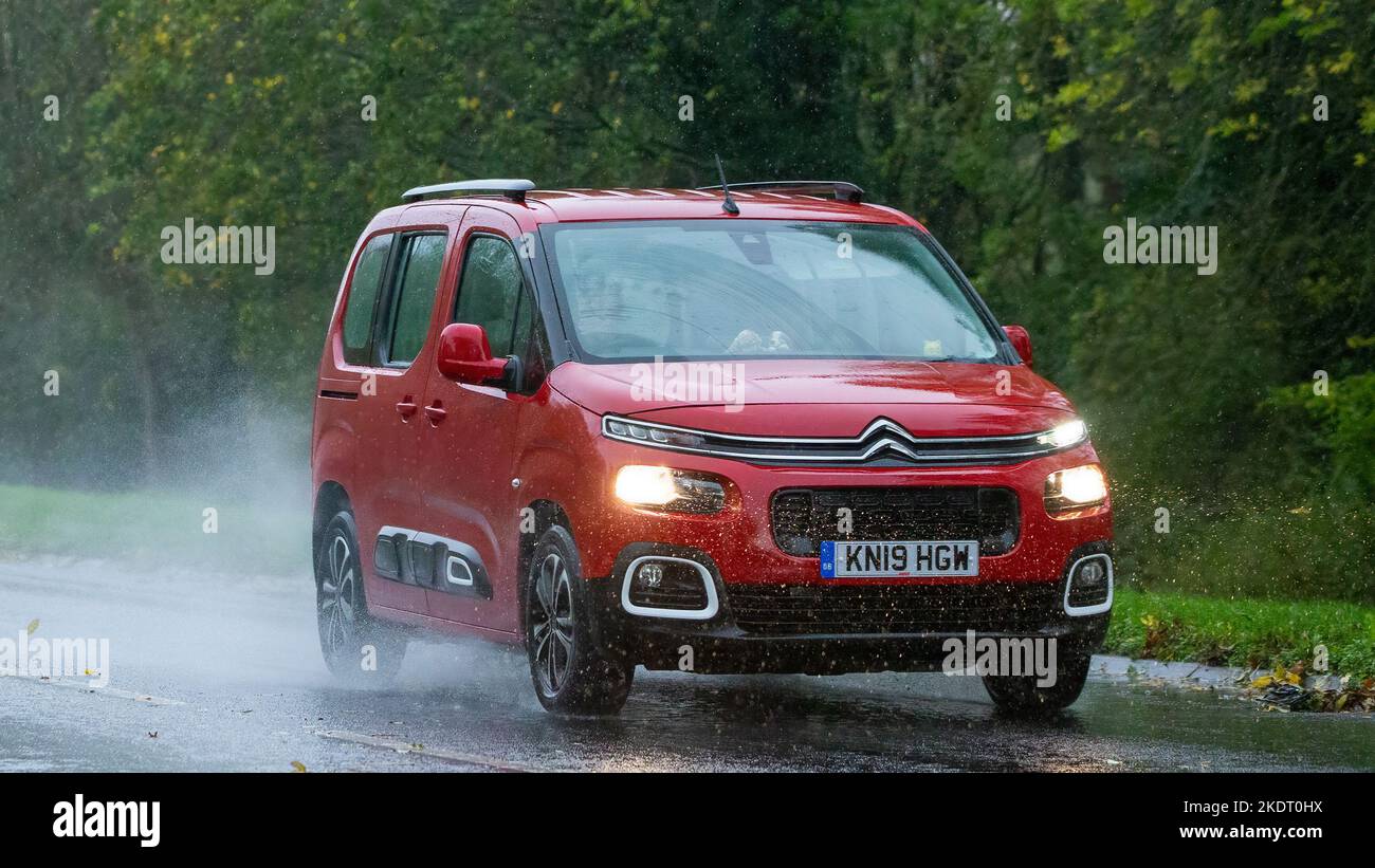 2019 red Citroen Berlingo car driving in the rain on a wet road Stock ...