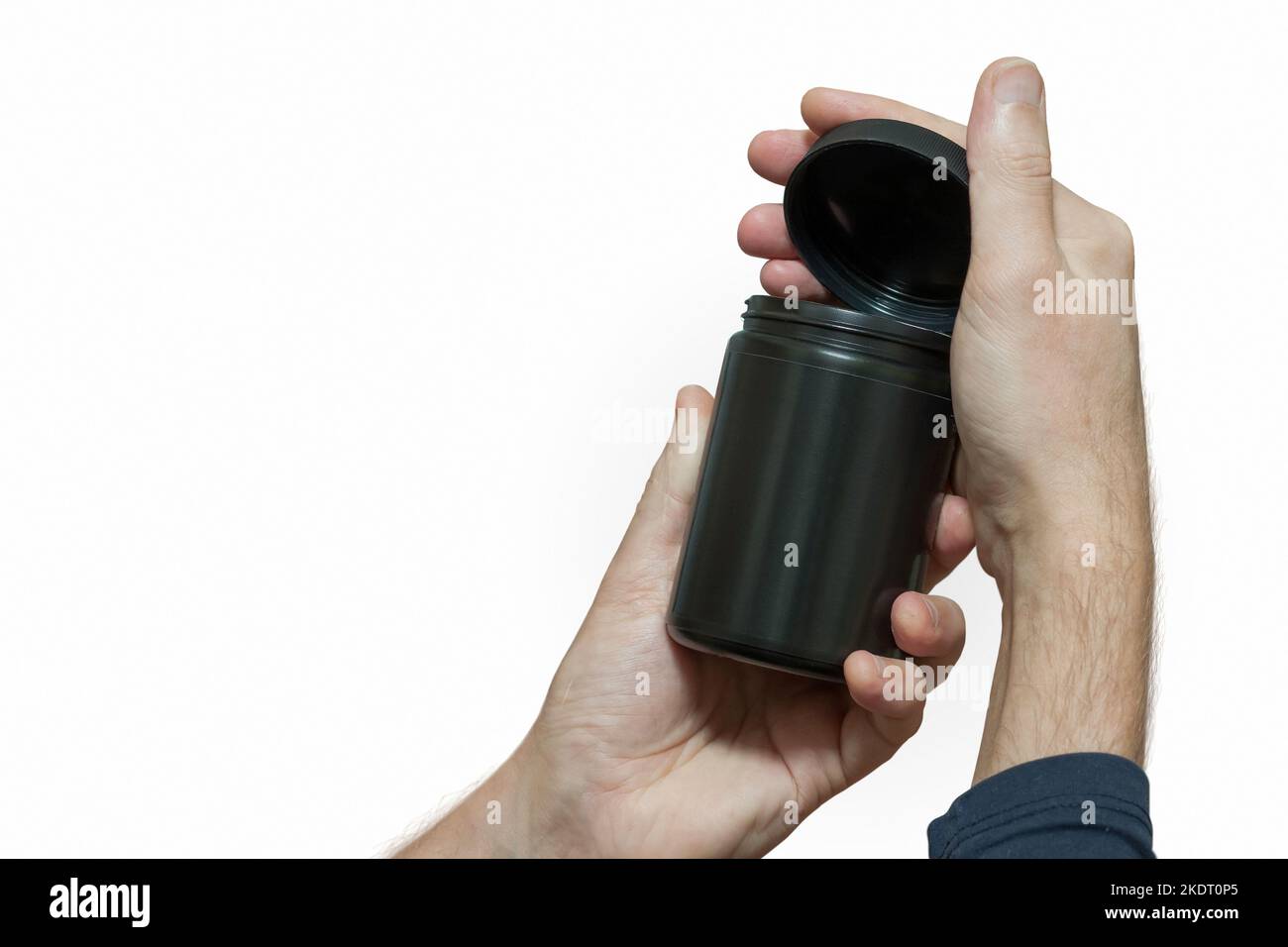 Opened plastic bottle for pills or vitamin capsule in the hands ...