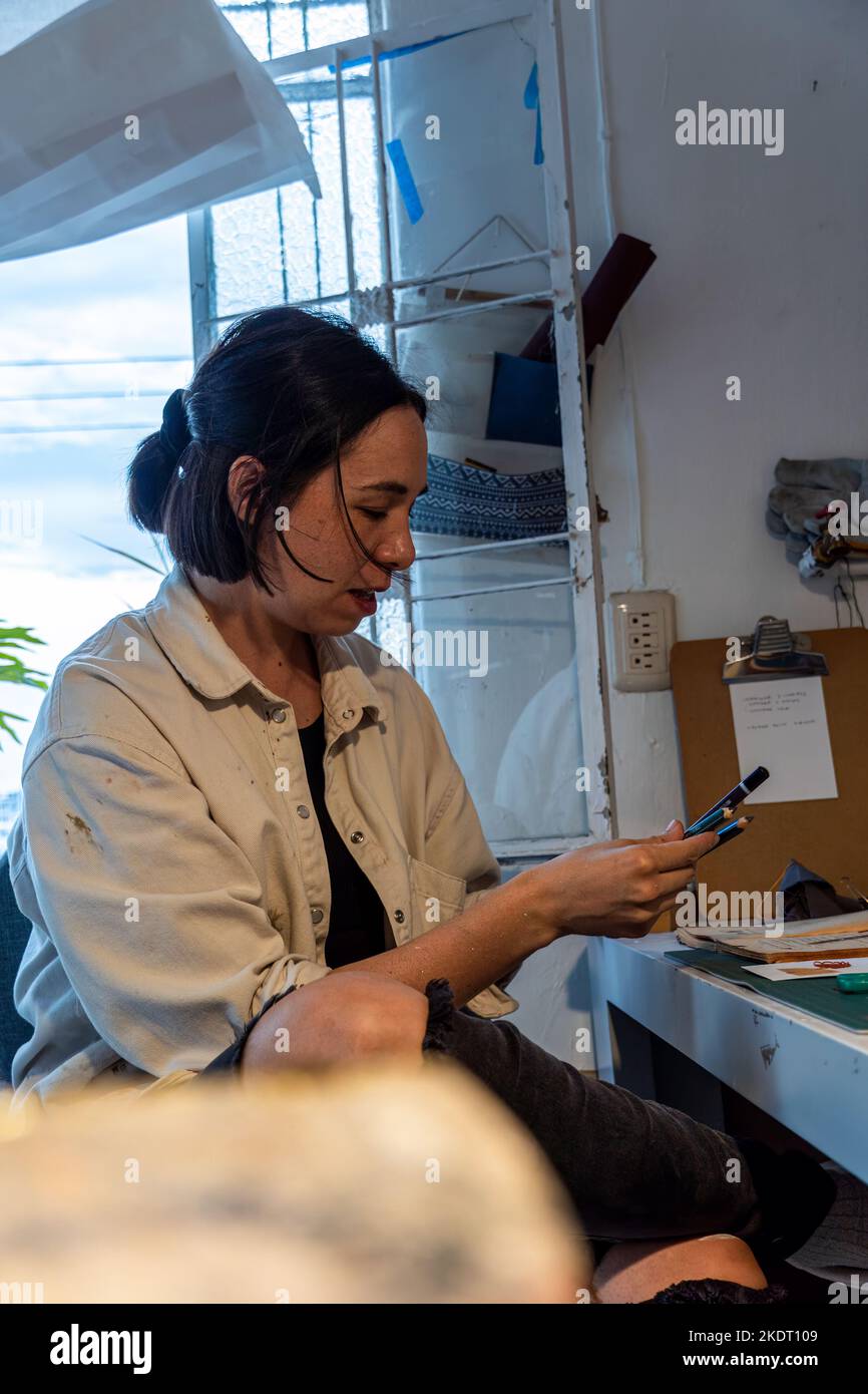 painting on blank canvas, hispanic woman with brushes and oil painting ...
