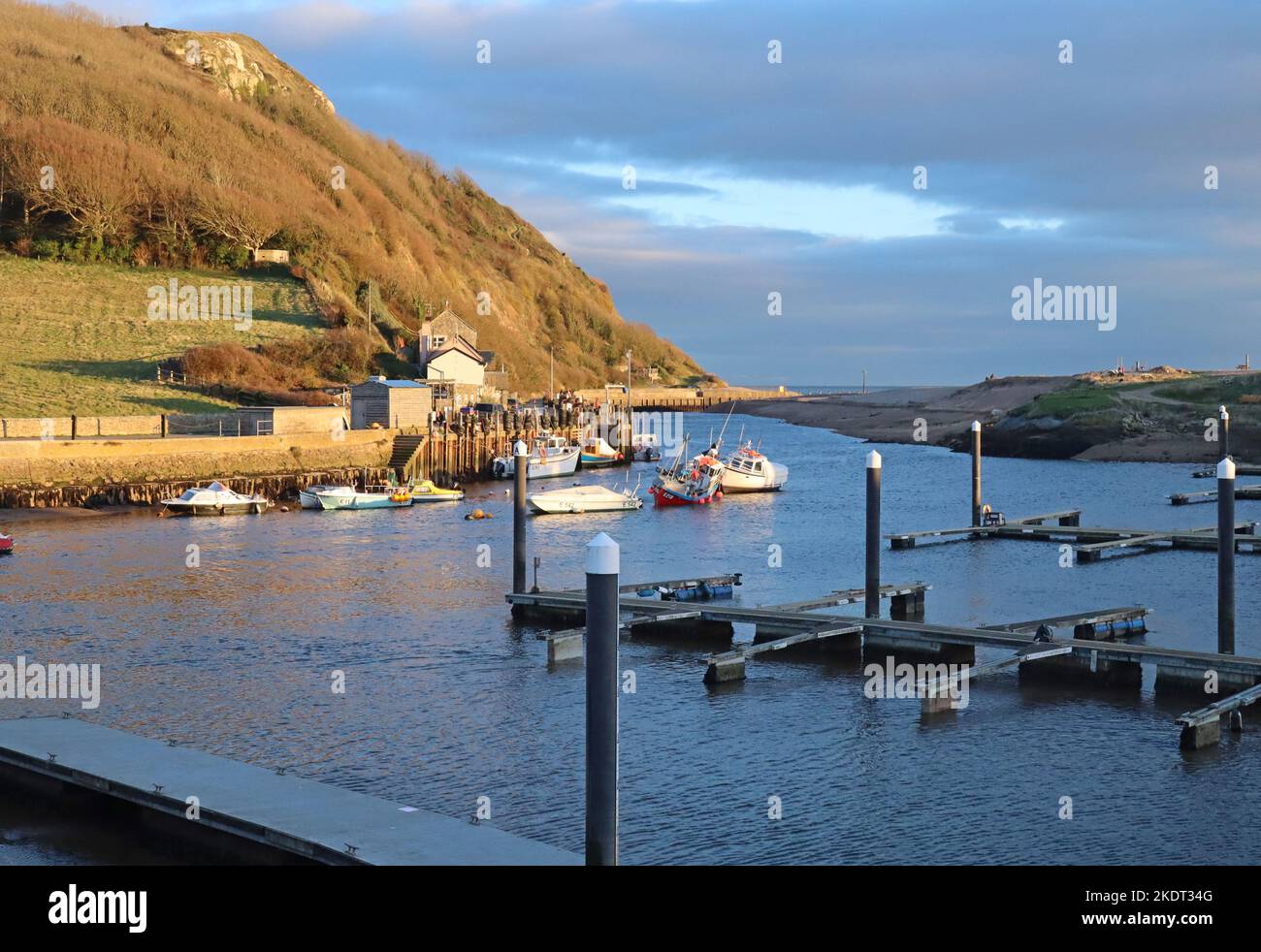 A stormy sky and evening sun on the estuary at Axmouth, in Devon on the ...