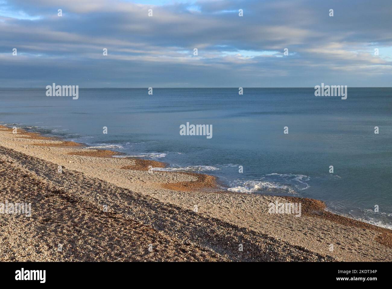 The waves in the sea create strange shapes in the pebble beach at ...