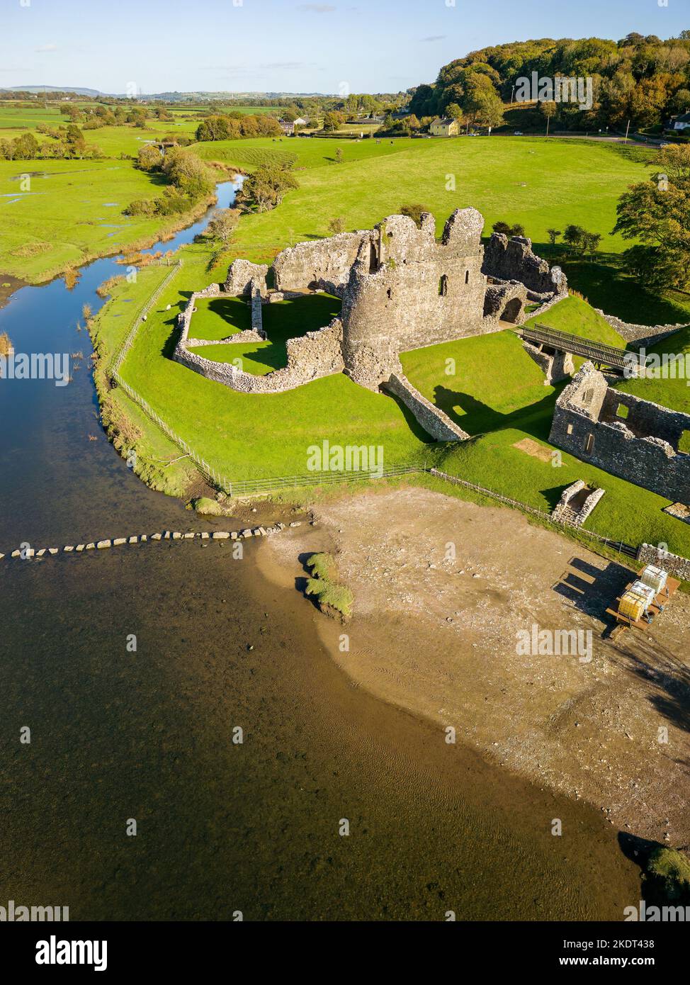 Aerial view of stepping stones over a small river leading to the ruins ...
