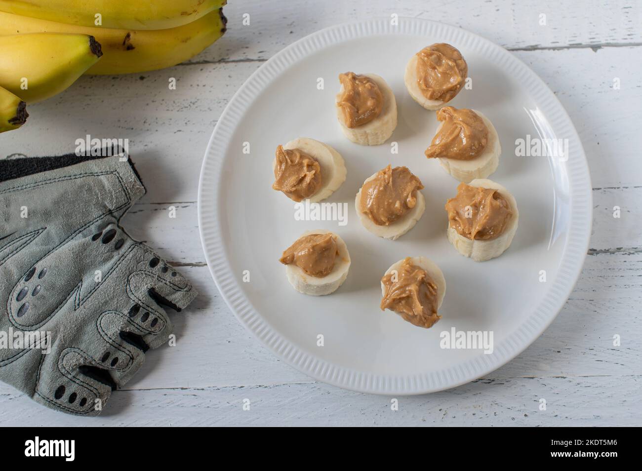 Healthy fitness snack with sliced banana and crunchy peanut butter ...