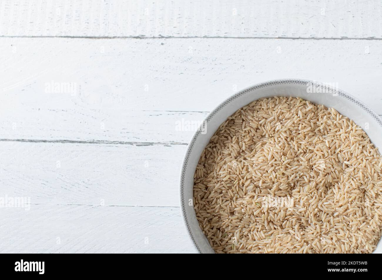 Raw and uncooked brown rice on white background Stock Photo - Alamy