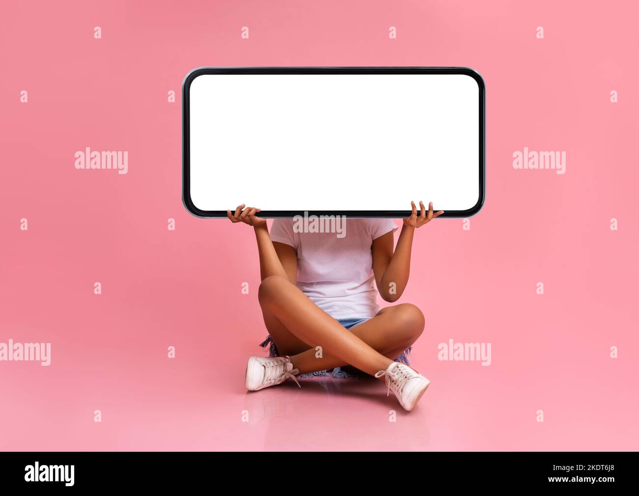 Unrecognizable Black Teen Girl Hiding Behind Big Blank Smartphone With ...