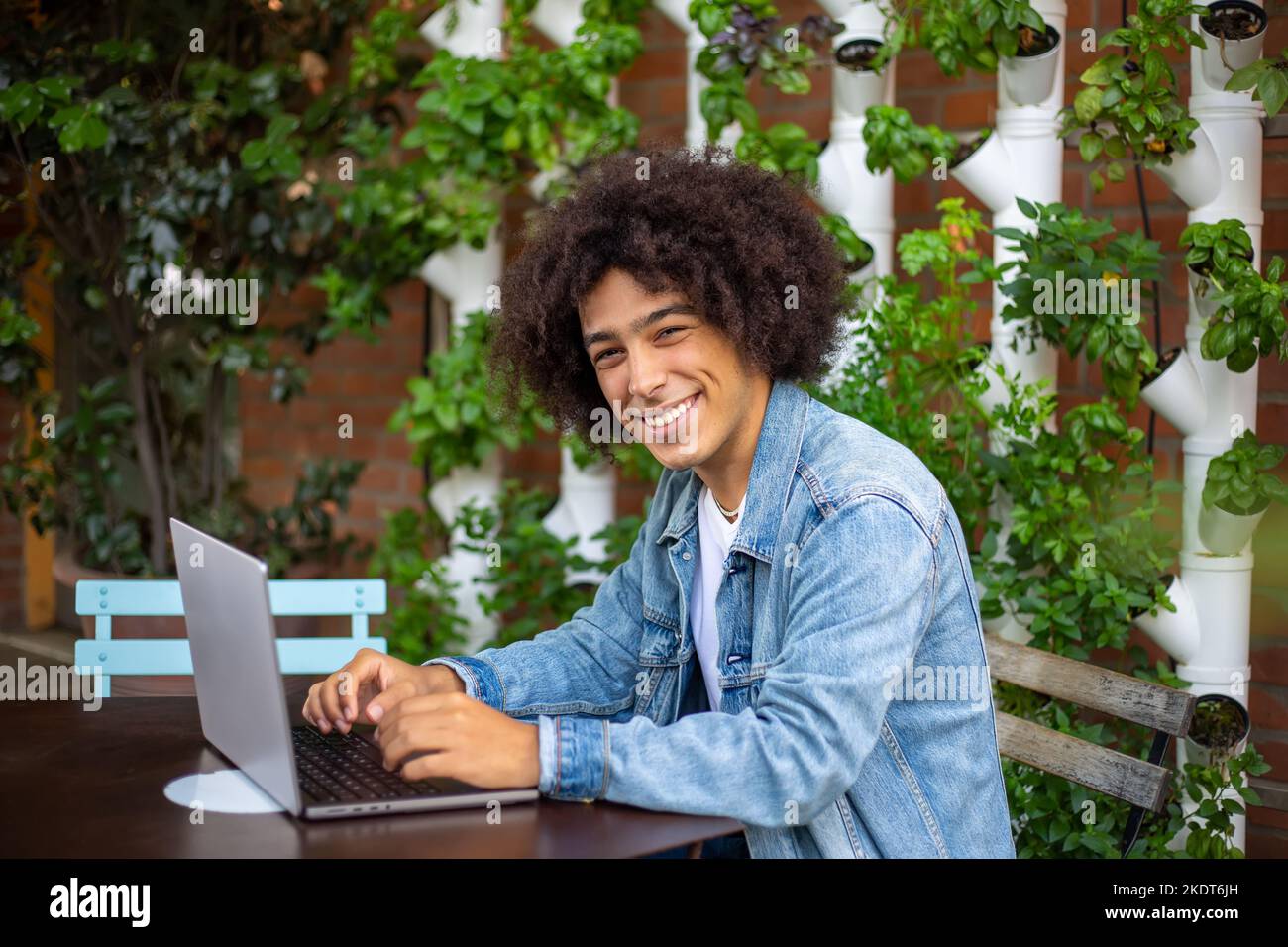 Smiling young mixed race Afro-Italian man, dressed in casual clothes ...