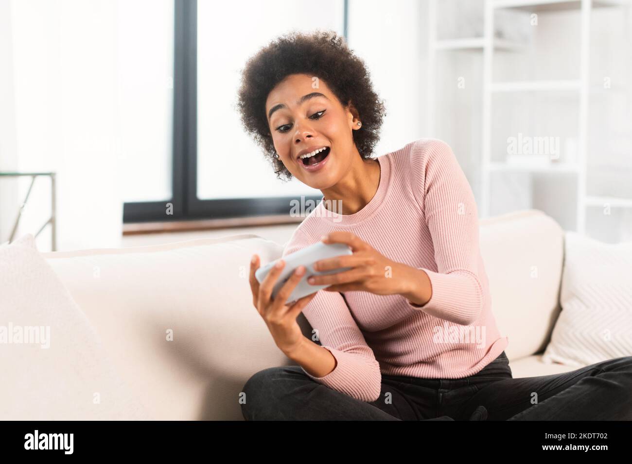 Lady playing game on phone hi-res stock photography and images - Alamy