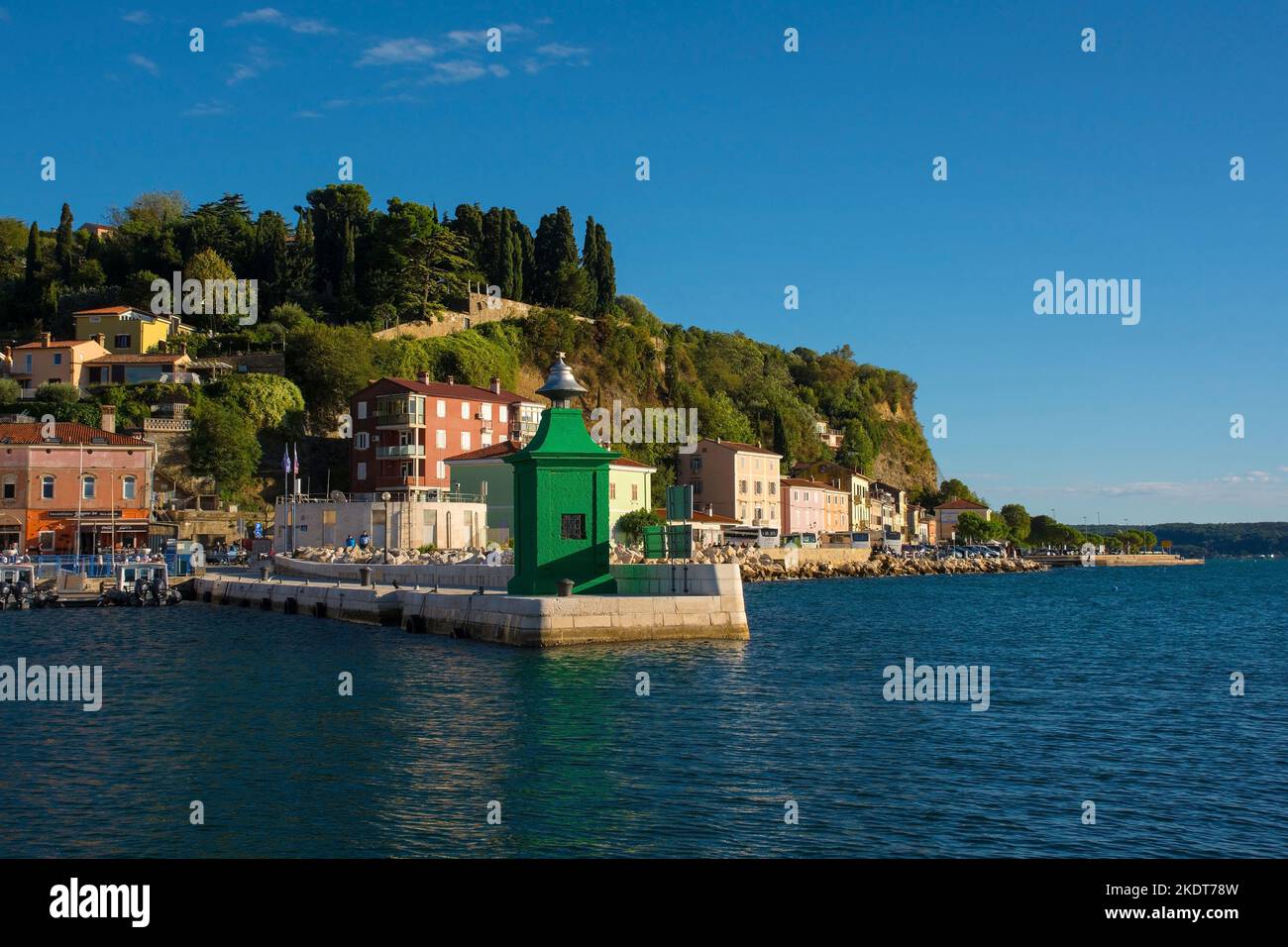 Piran, Slovenia - September 17th 2022. A small green lighthouse on the ...