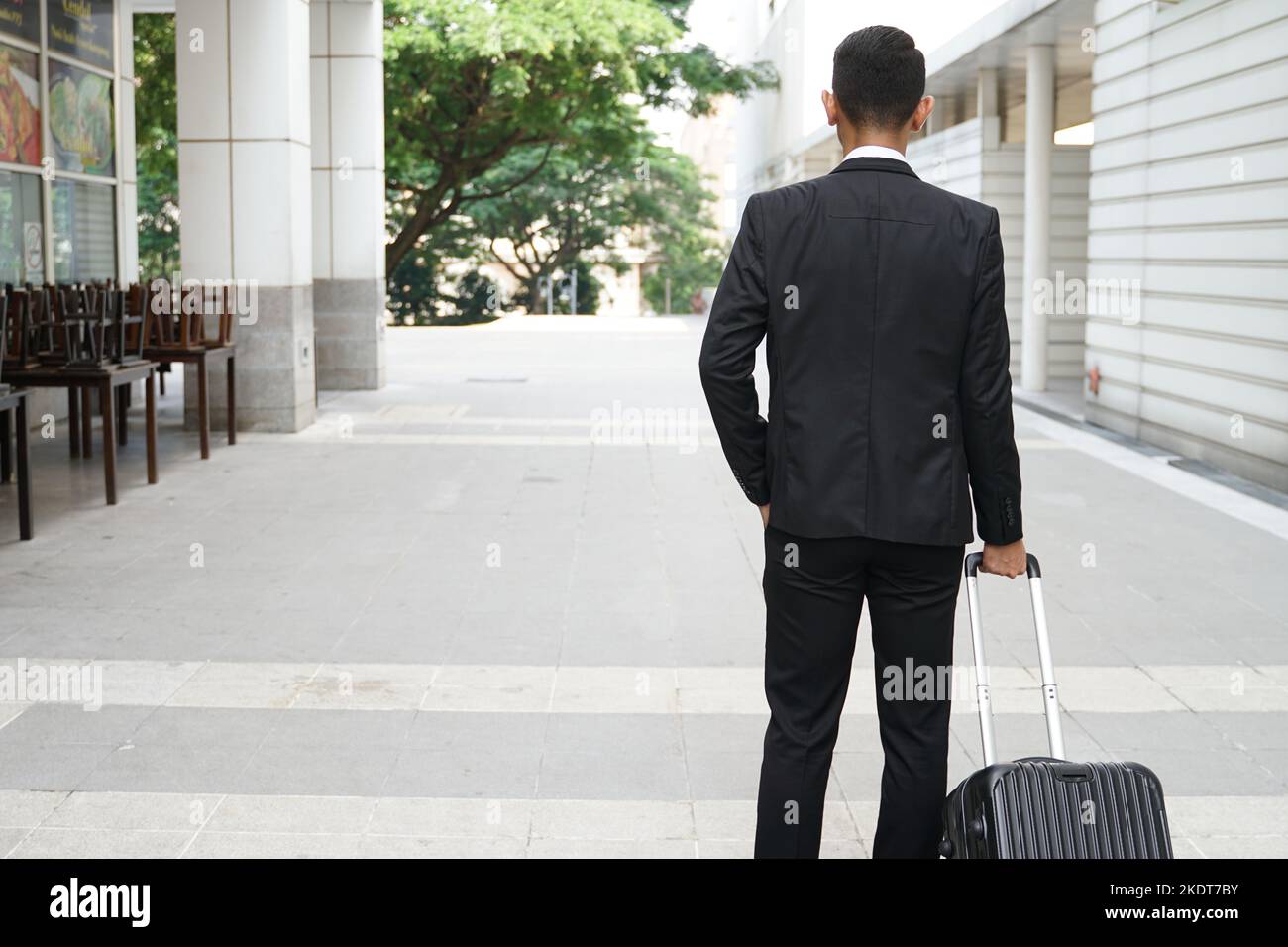 Back view young businessman walking hi-res stock photography and images ...