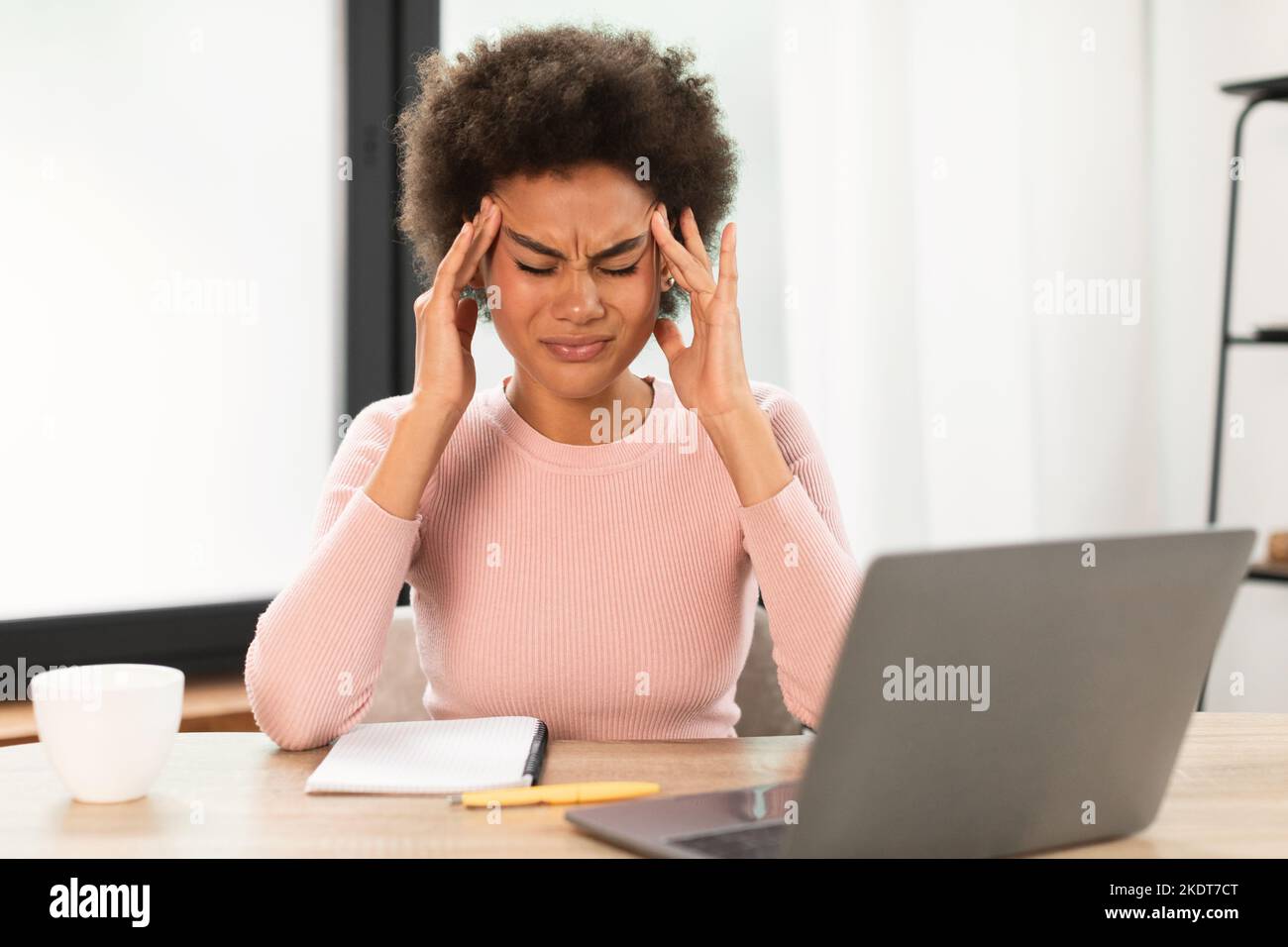 Sad tired millennial african american woman with laptop suffering from ...