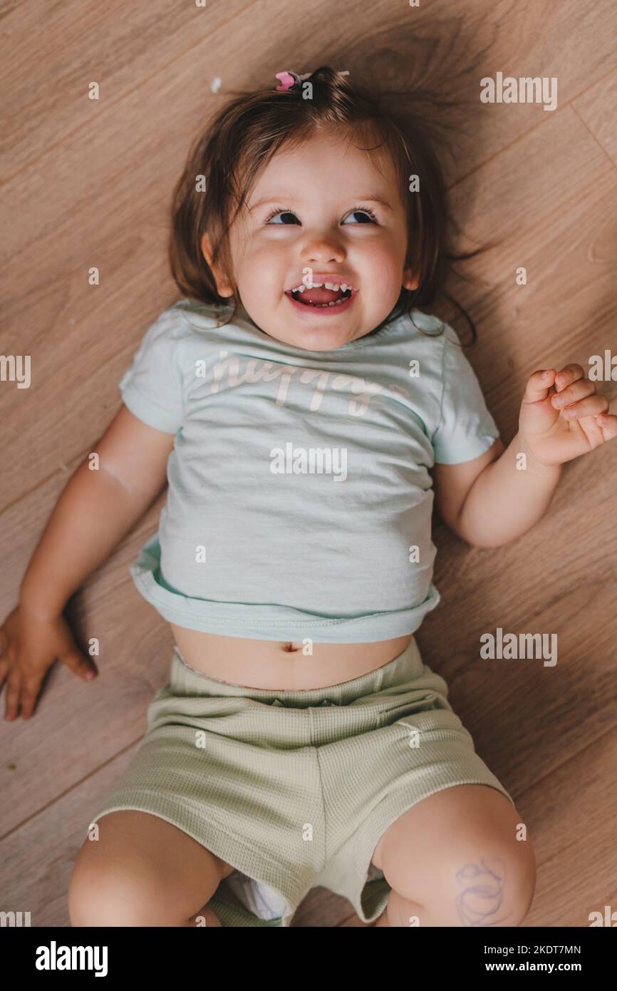 Baby smile lying floor hi-res stock photography and images - Alamy