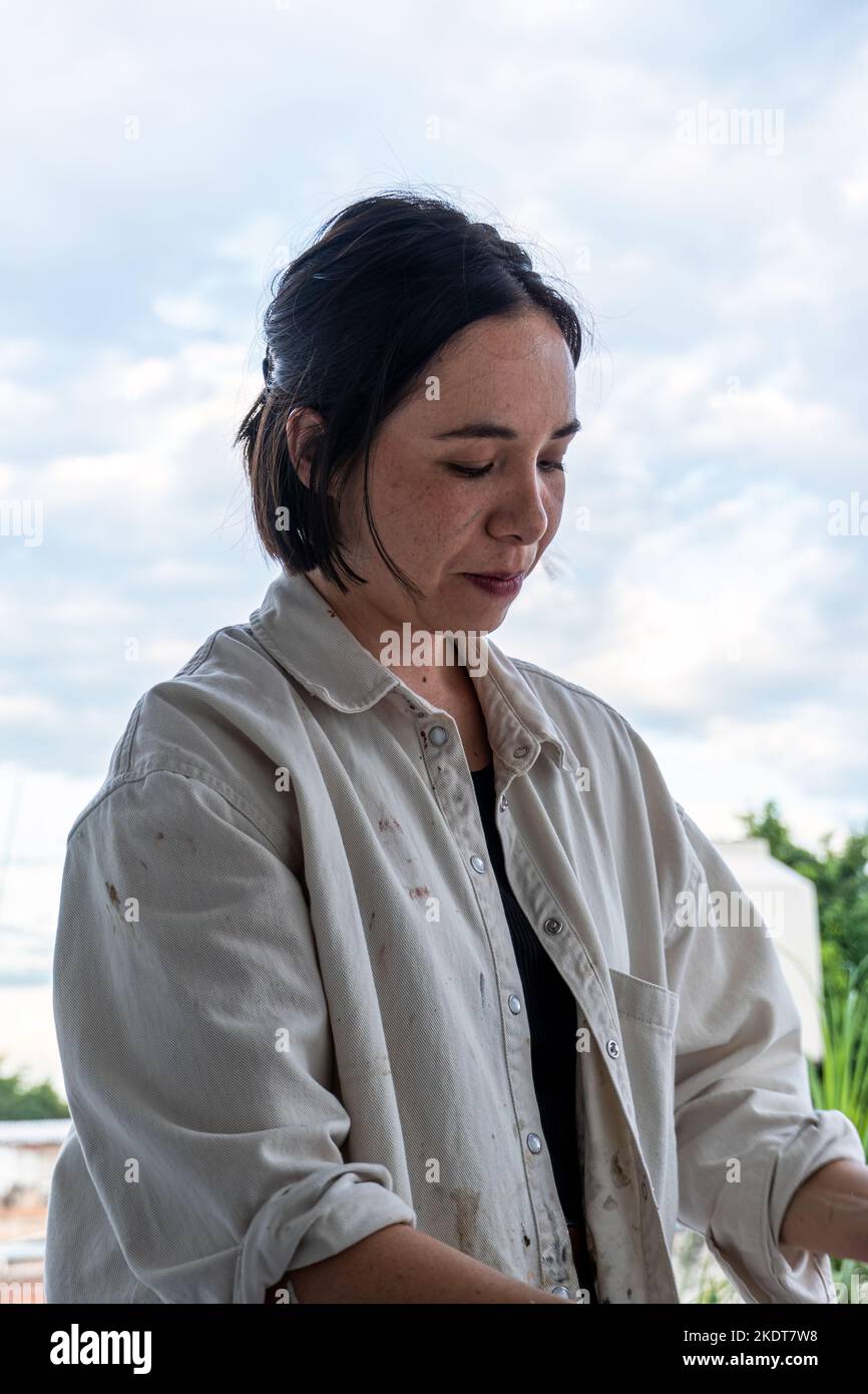 art workshop, messy objects, brushes, paint all mixed up disorganized ...