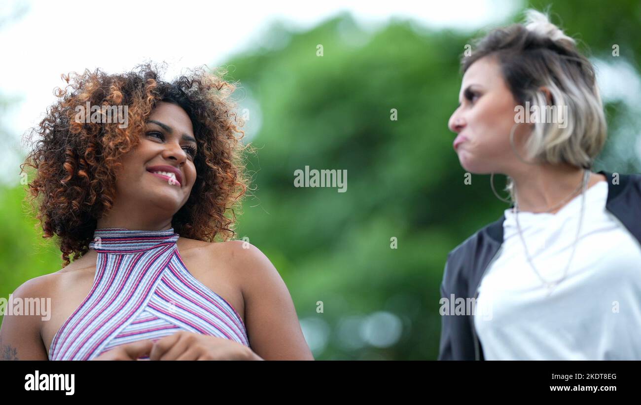 Two Brazilian friends hanging together outside in street. diverse ...