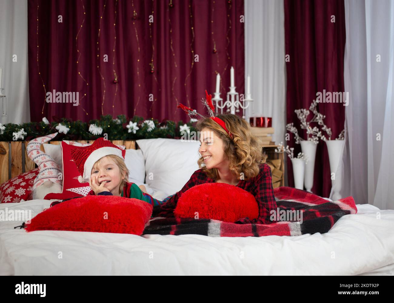 Christmas Eve at home with family. The elder sister and younger brother ...