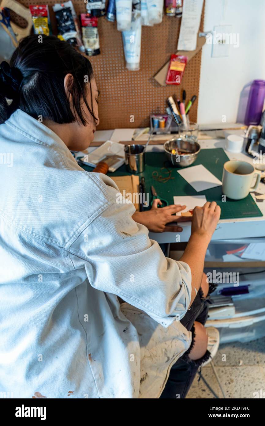 art workshop, messy objects, brushes, paint all mixed up disorganized ...